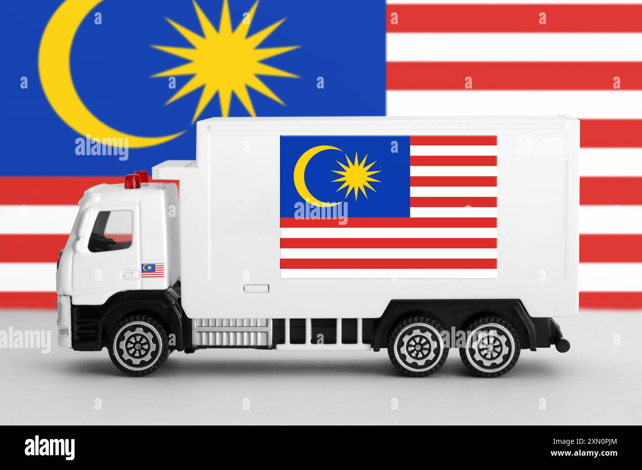 Malaysia flag depicted on side wall of white delivery van close up ...