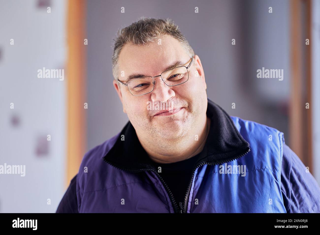 Large build man smiles cheekily, his face in glasses close-up Stock ...