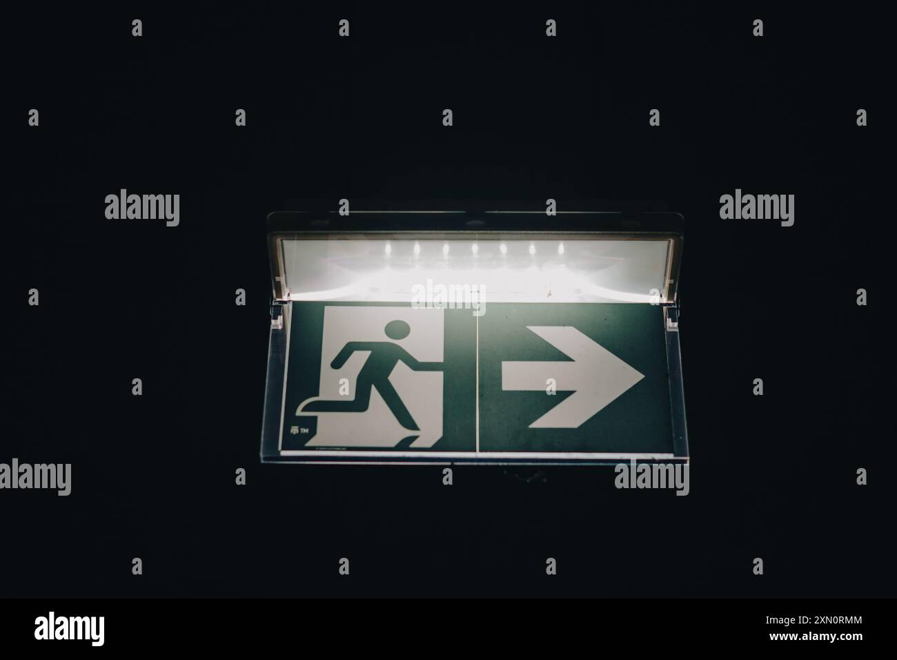 Exit sign in a underground parking garage Stock Photo - Alamy