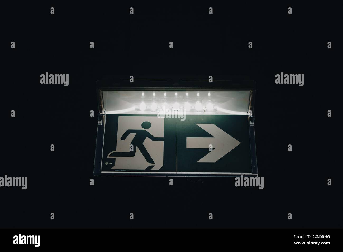 Exit sign in a underground parking garage Stock Photo - Alamy