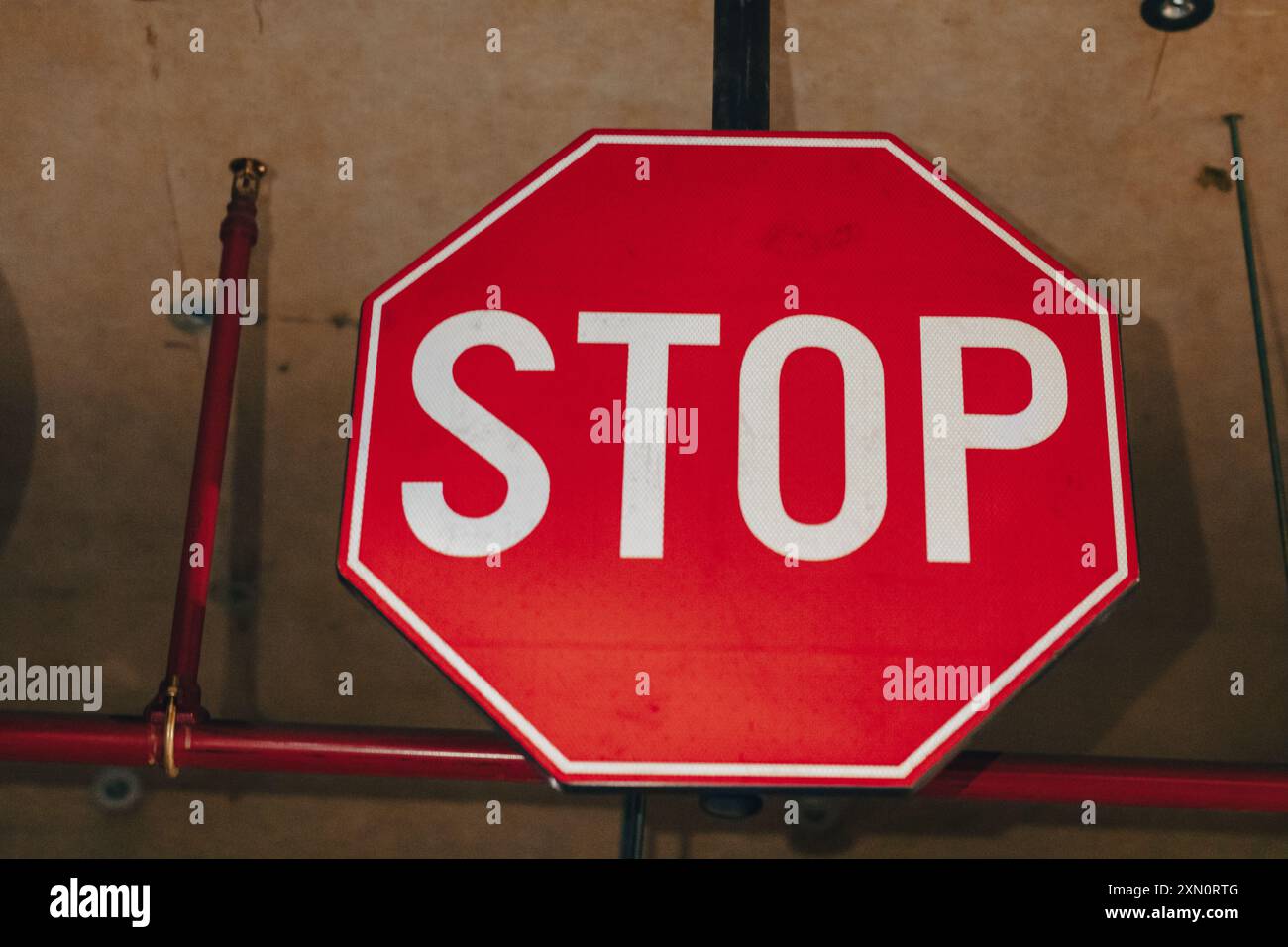 Red stop sign in a underground parking garage Stock Photo - Alamy