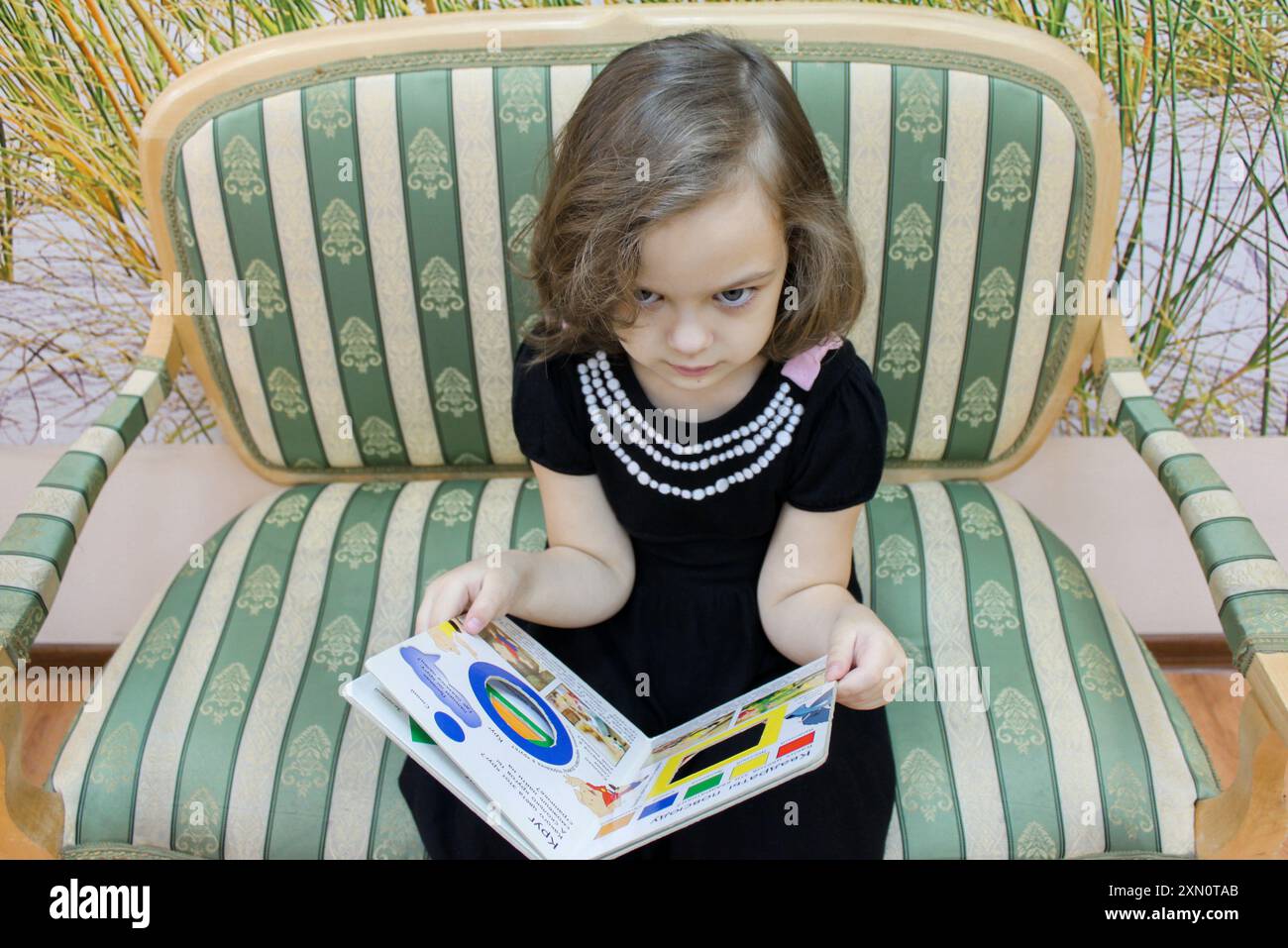 Moscow, Russia, May 2013: Angry blonde toddler girl with book with ...