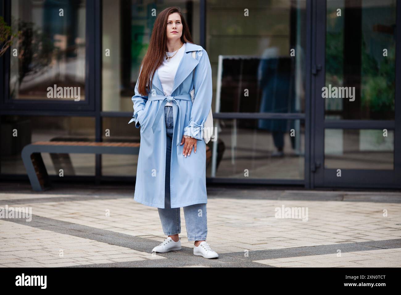 Plus size young woman stands outdoors modern urban setting contemporary ...