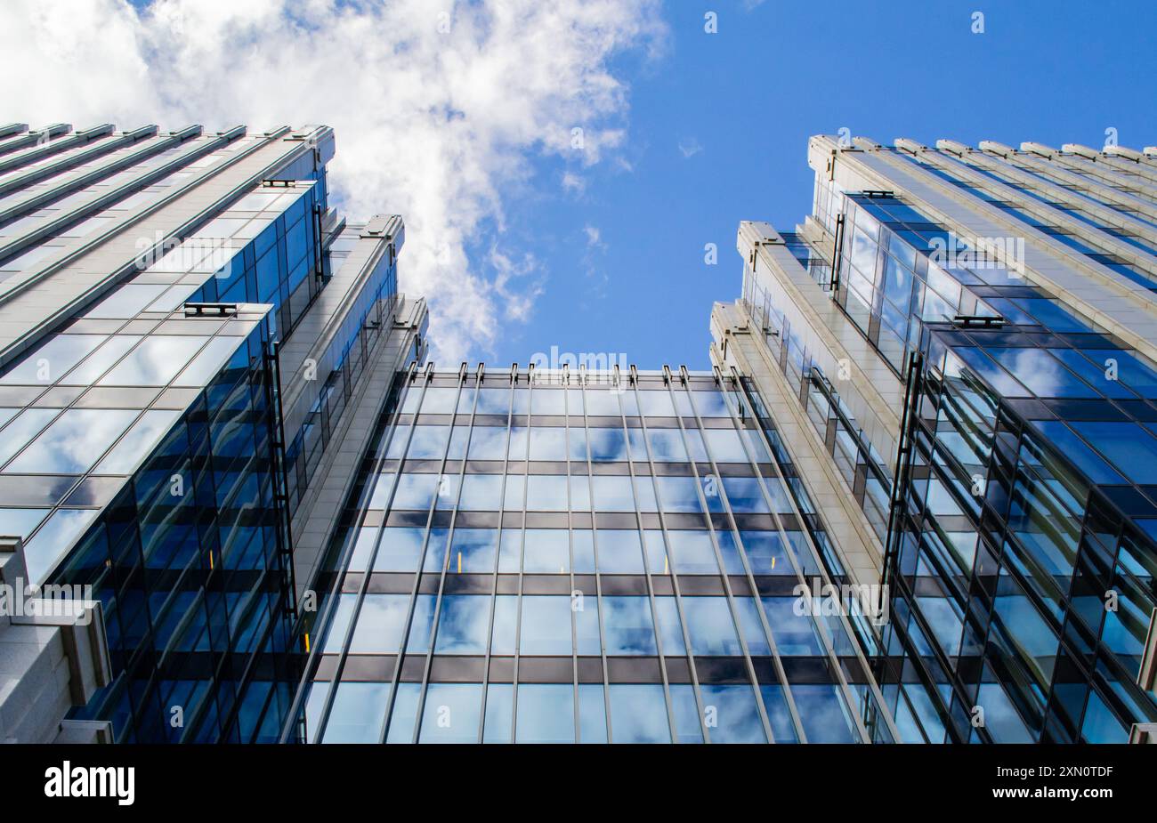 A view from the bottom up to a modern tall office building with ...