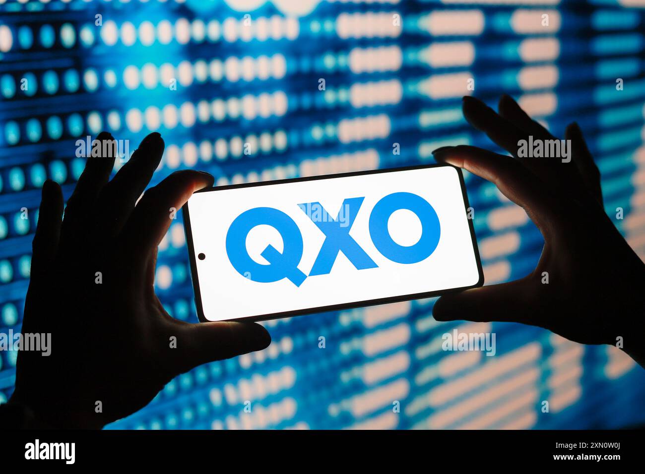 In this photo illustration, the QXO, Inc. logo is displayed on a ...