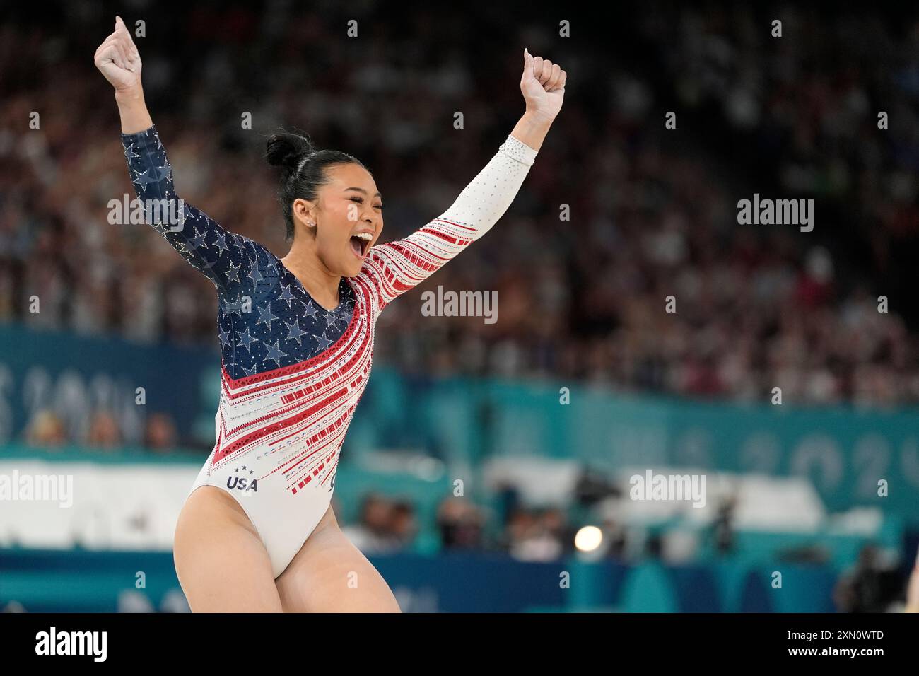 Suni Lee, of the United States, celebrates after performing on the ...