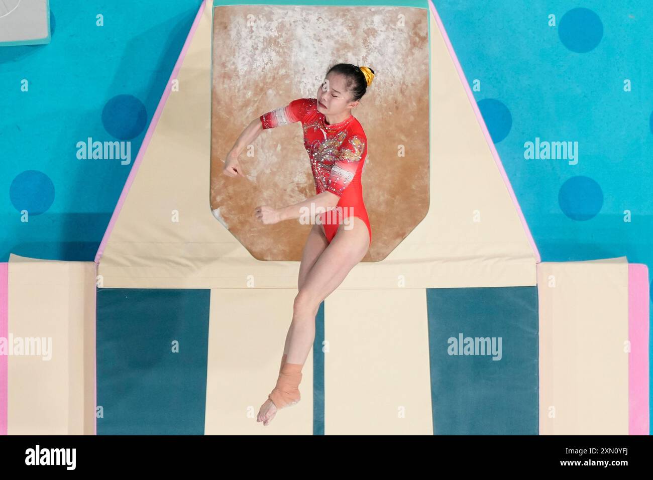 Yihan Zhang, of China, performs on the vault during the women's ...