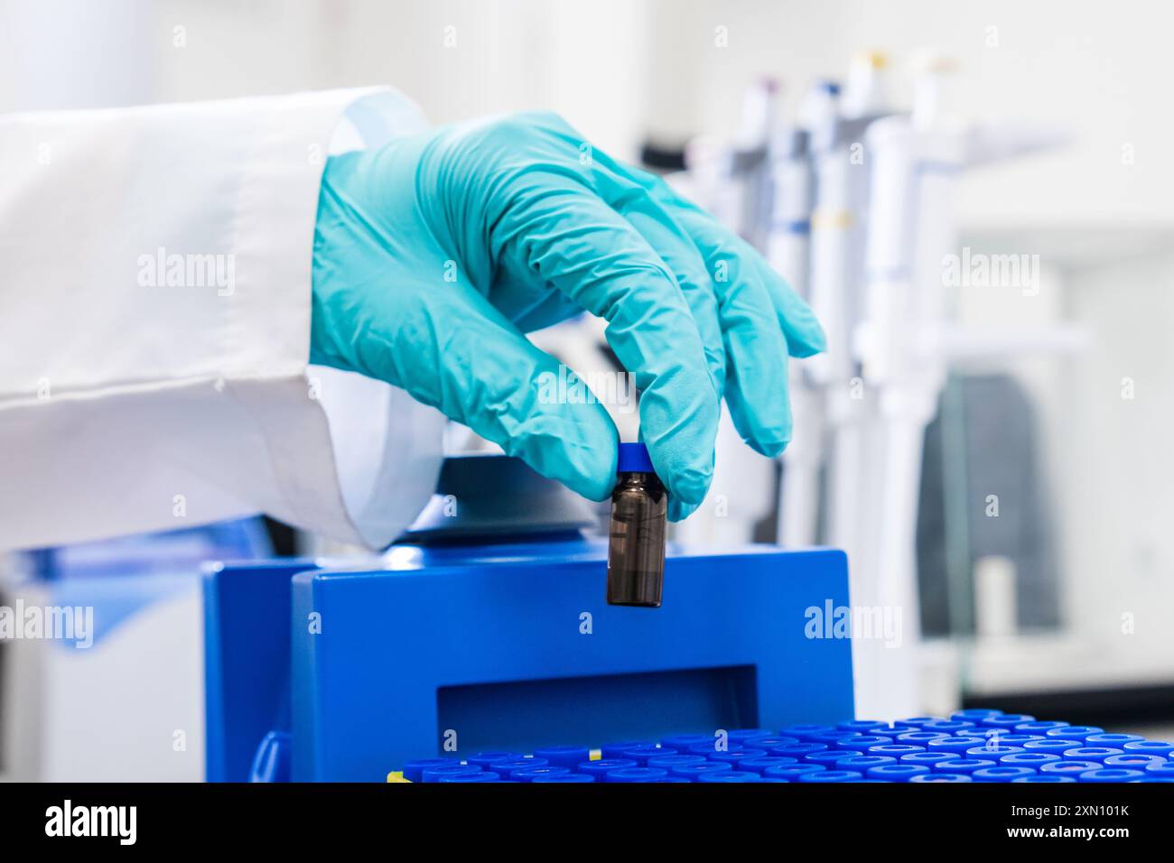A chemist uses a vortex mixer to shake samples before HPLC analysis ...