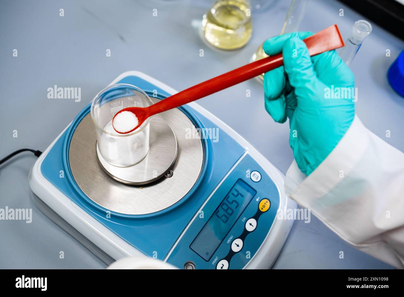 Top view woman is using laboratory balances to weigh powder samples ...