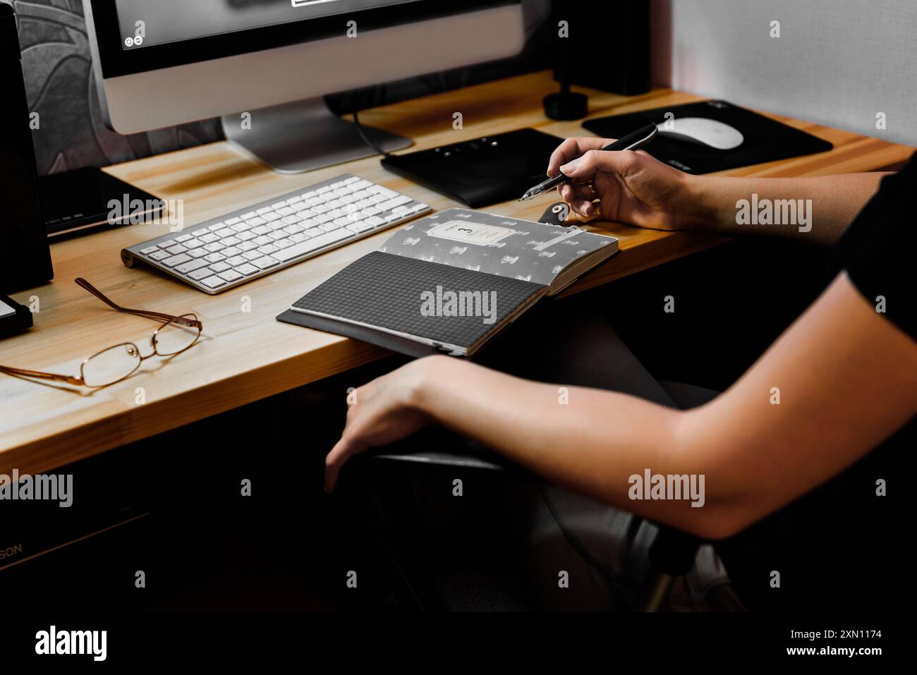 designer girl at work at the table draws on the tablet, close the ...