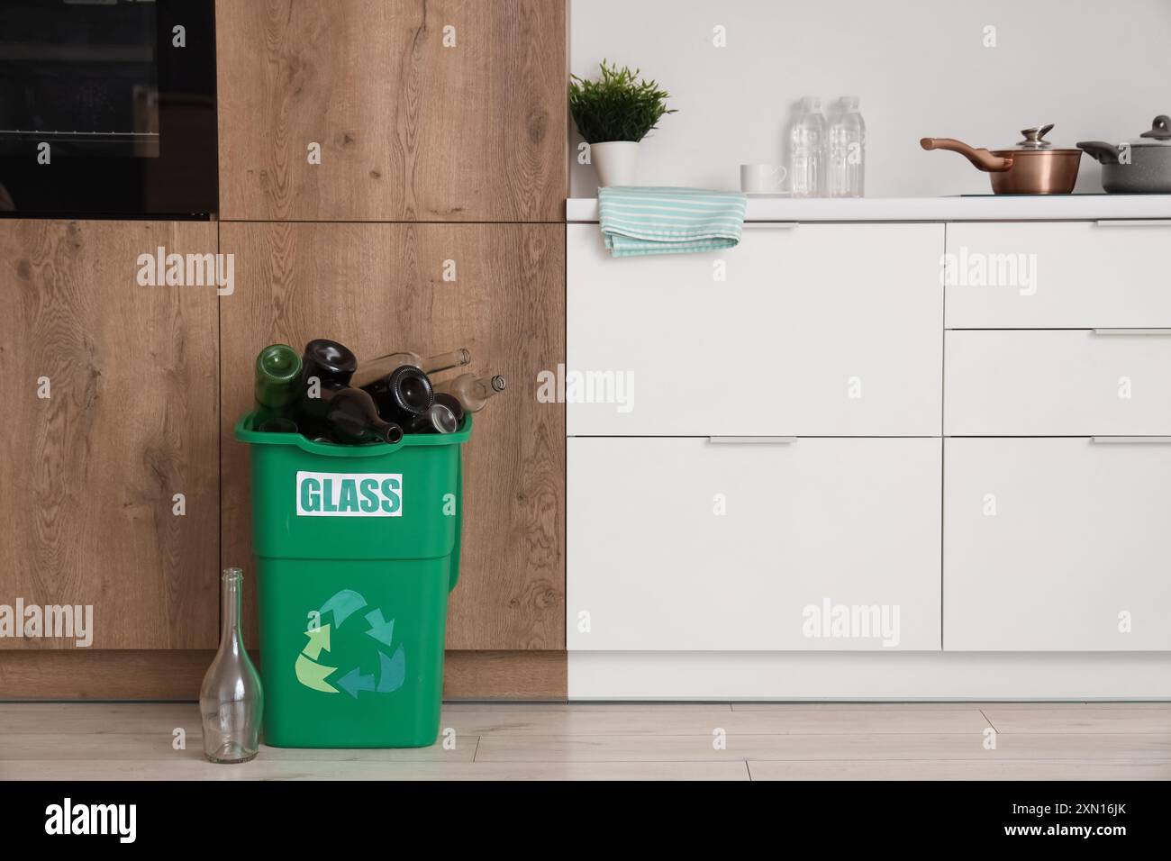 Full trash bin with GLASS sign in kitchen. Recycling concept Stock ...