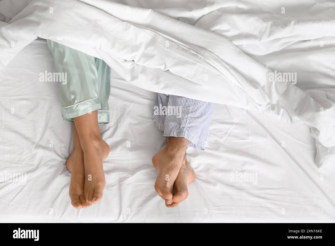 Feet couple sleeping in bed hi-res stock photography and images - Alamy