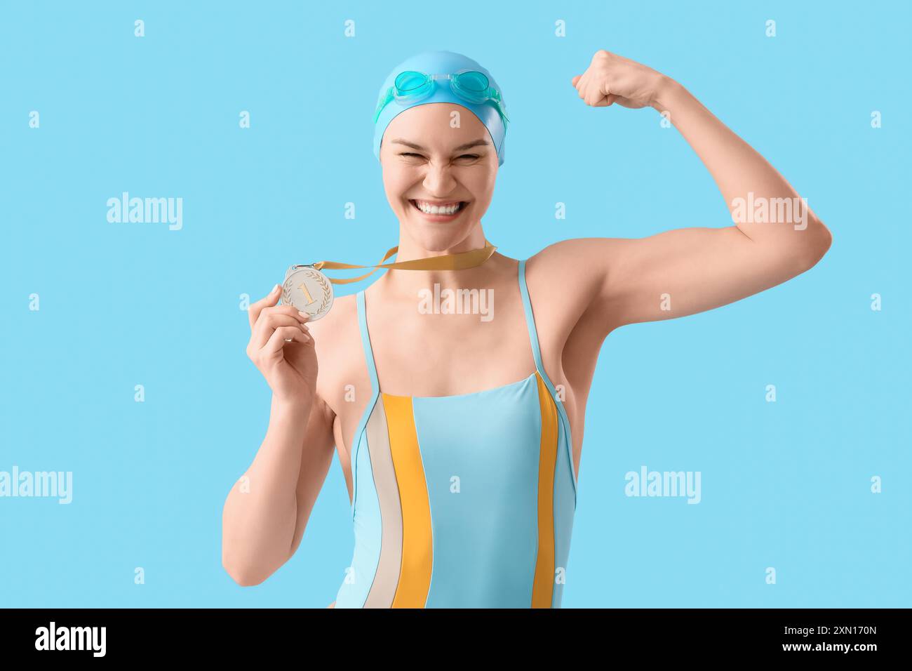Professional young female swimmer with first place medal showing ...