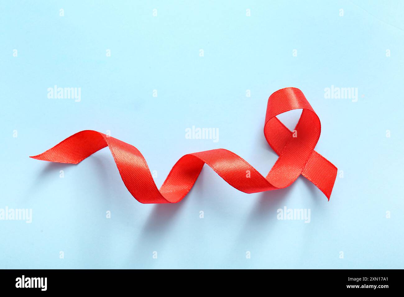 Red ribbon on blue background. Blood Cancer Awareness Month Stock Photo ...