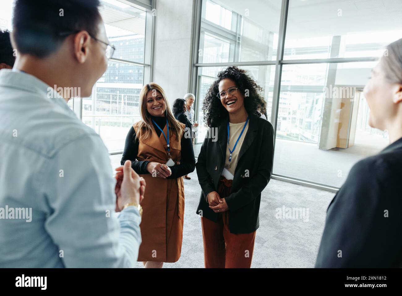 Group of colleagues engaging in networking at a corporate event ...