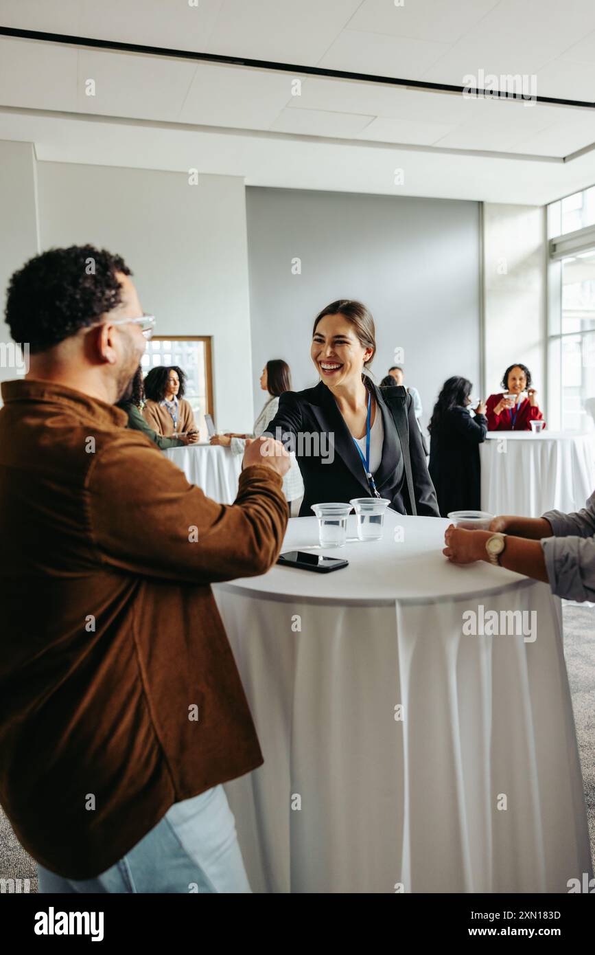 Corporate professionals mingle and enjoy refreshments at a networking ...
