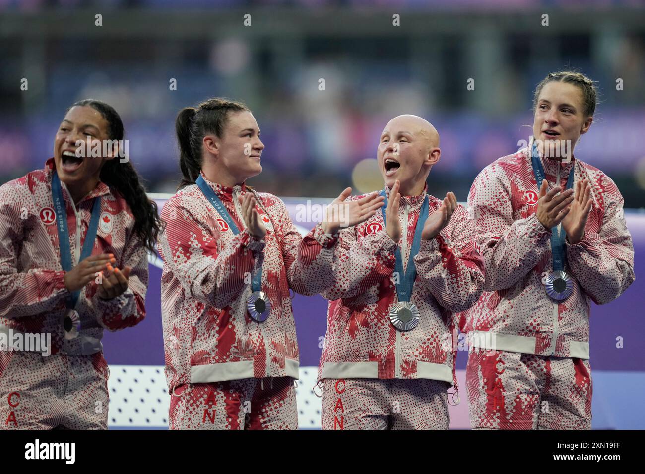Members of the Canadian Rugby Sevens team celebrate on the podium with ...