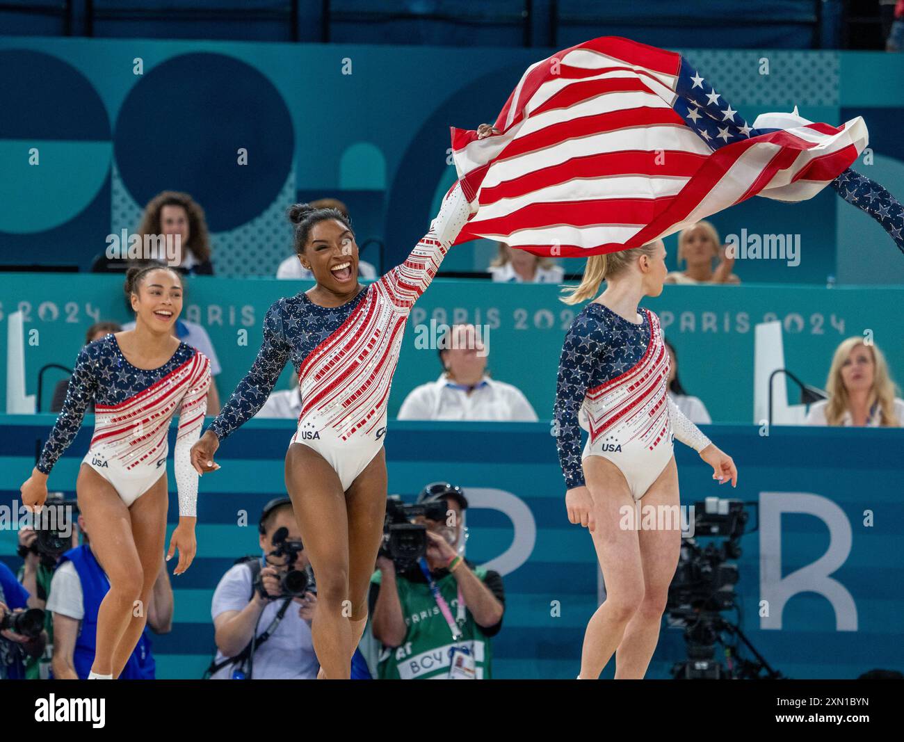 Paris, France. 30th July, 2024. Simone Biles waves an American Flag as ...