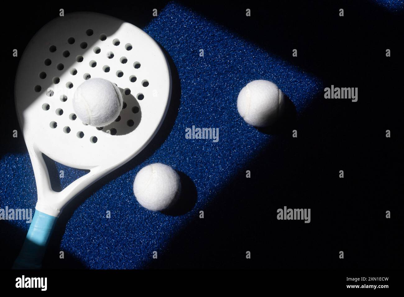 White professional paddle tennis racket and white balls with natural ...