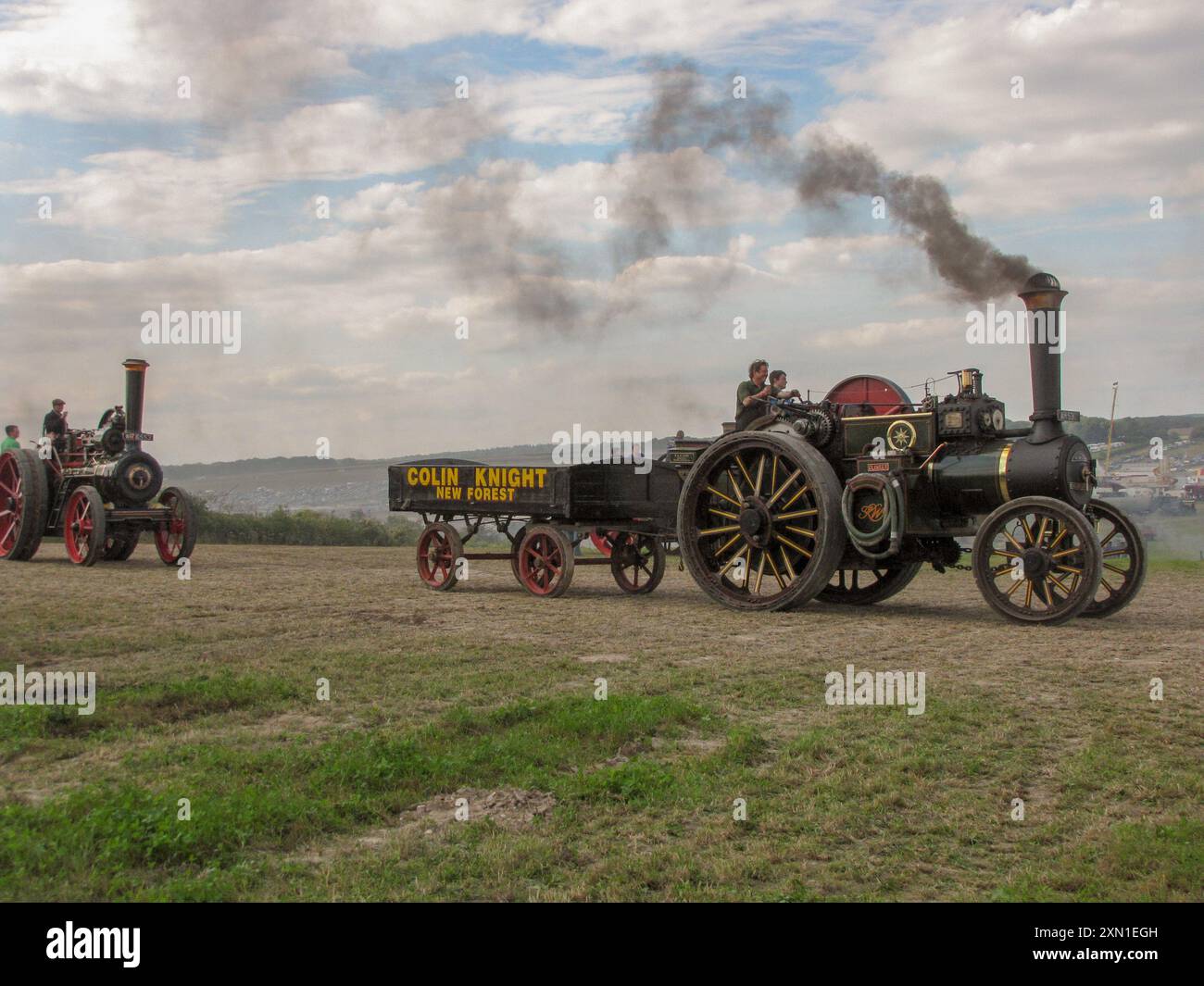 a beautiful historic steam engine is driving at a field in dorset with ...