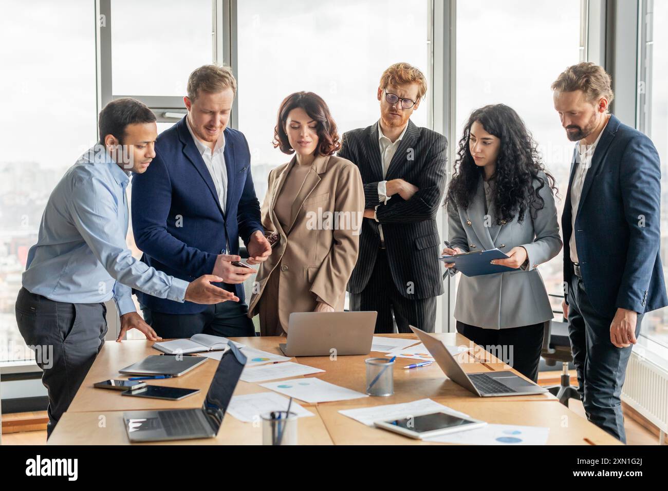 Business Professionals Collaborate Around Conference Table During ...