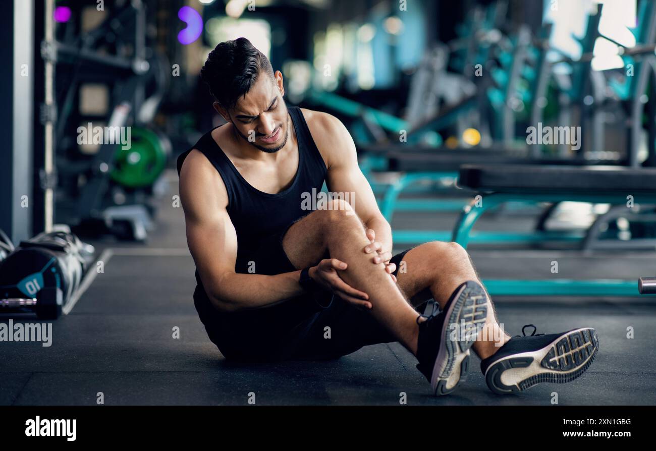 Sport Injury. Arab Male Athlete Suffering Knee Trauma While Training At ...