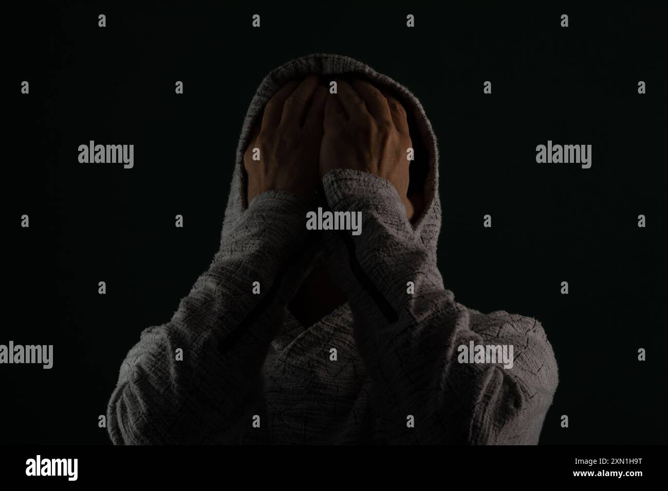 Hood covering face hi-res stock photography and images - Alamy