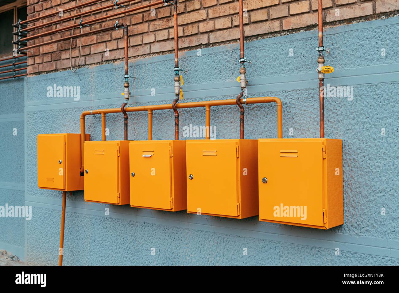 Gas consumption meter yellow boxes on building exterior wall, selective ...