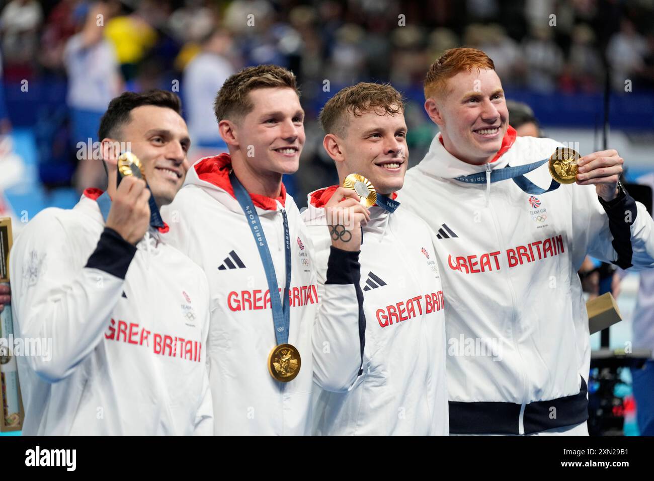Britain s Gold Medal Men s 4x200 meter Freestyle Relay Team Pose For A