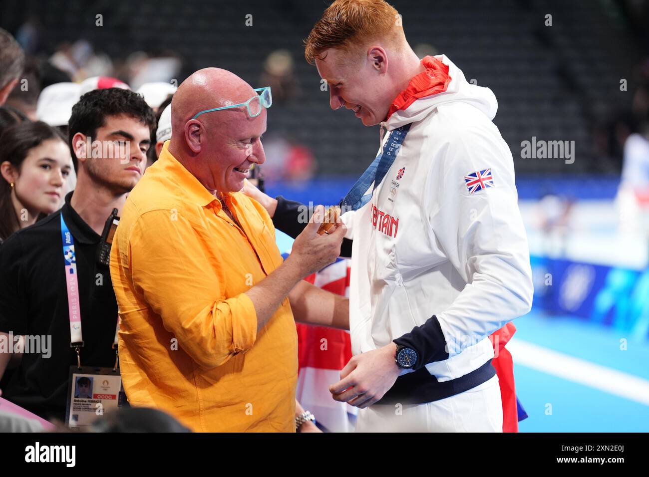 Great Britain's Tom Dean (right) shows his father, Jonathan Dean, his ...