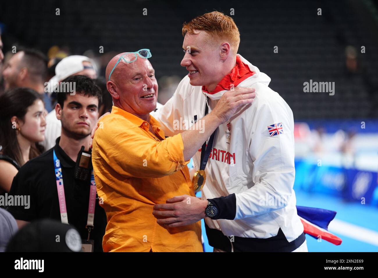 Great Britain's Tom Dean (right) shows his father, Jonathan Dean, his ...