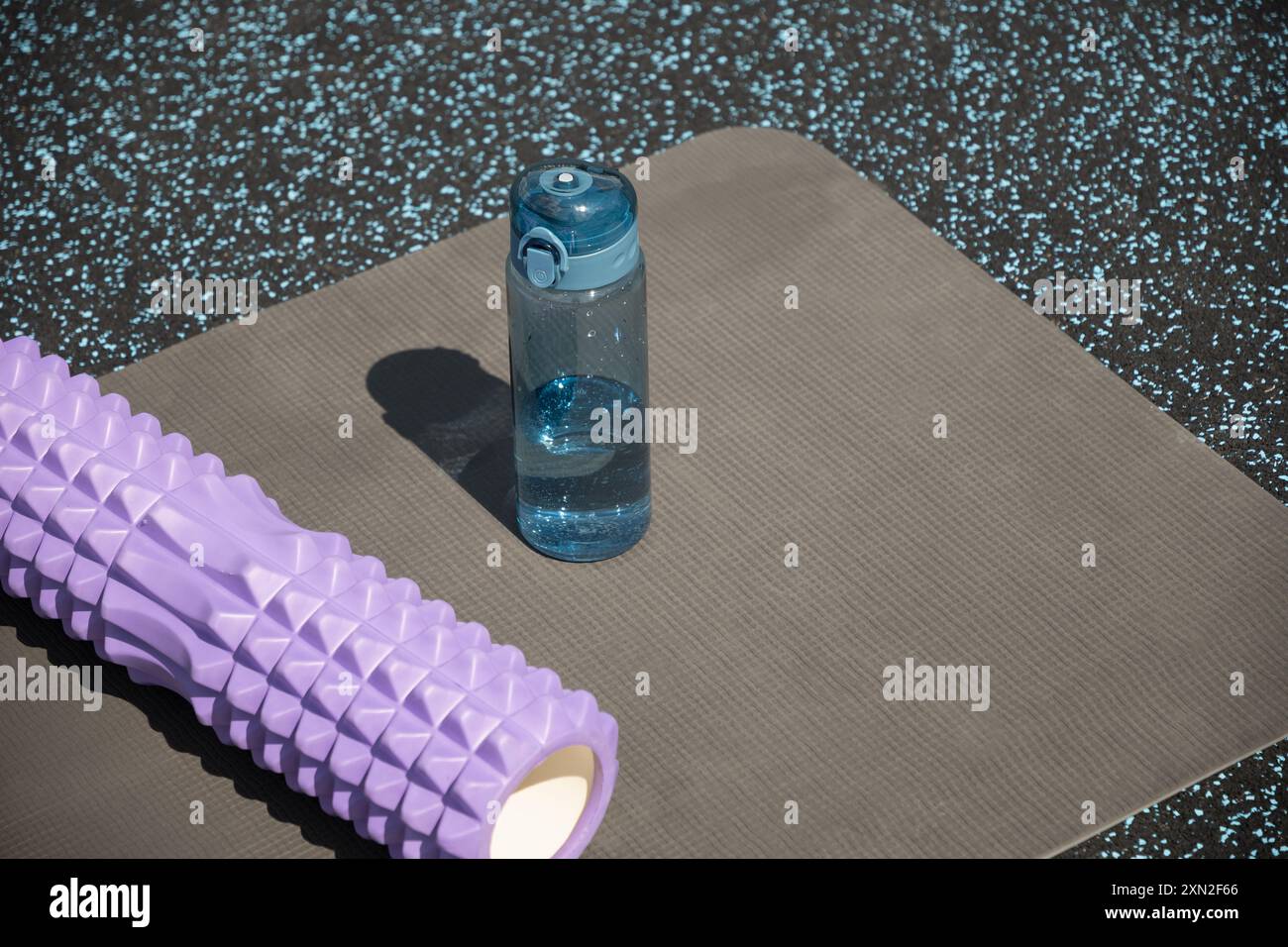 Foam roller and exercising mat on sports ground for training. Outdoor ...