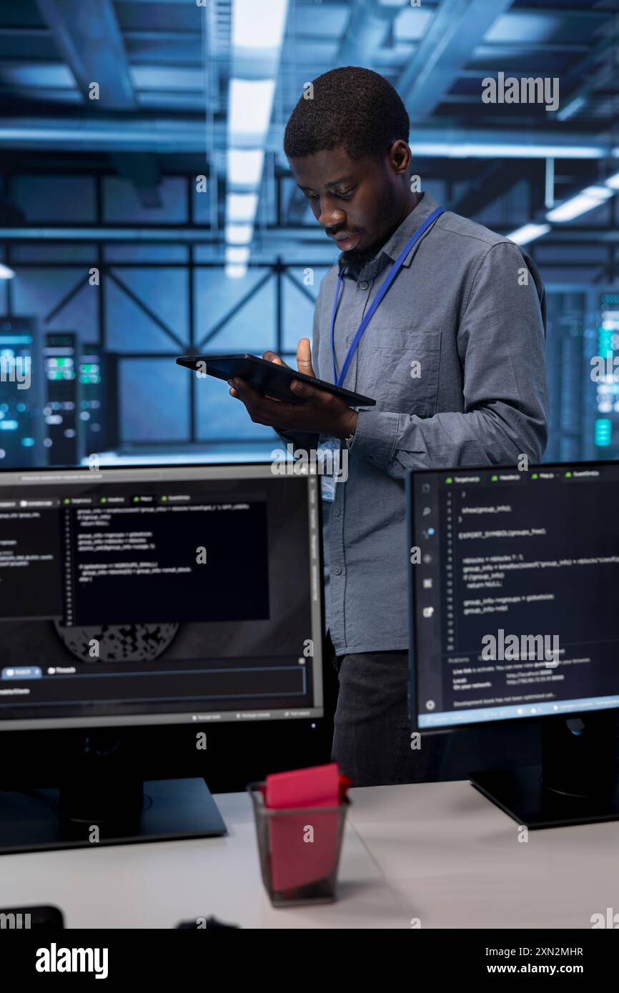 Admin In Data Center Using Diagnostic Tools And System Monitoring Software On Tablet Device To