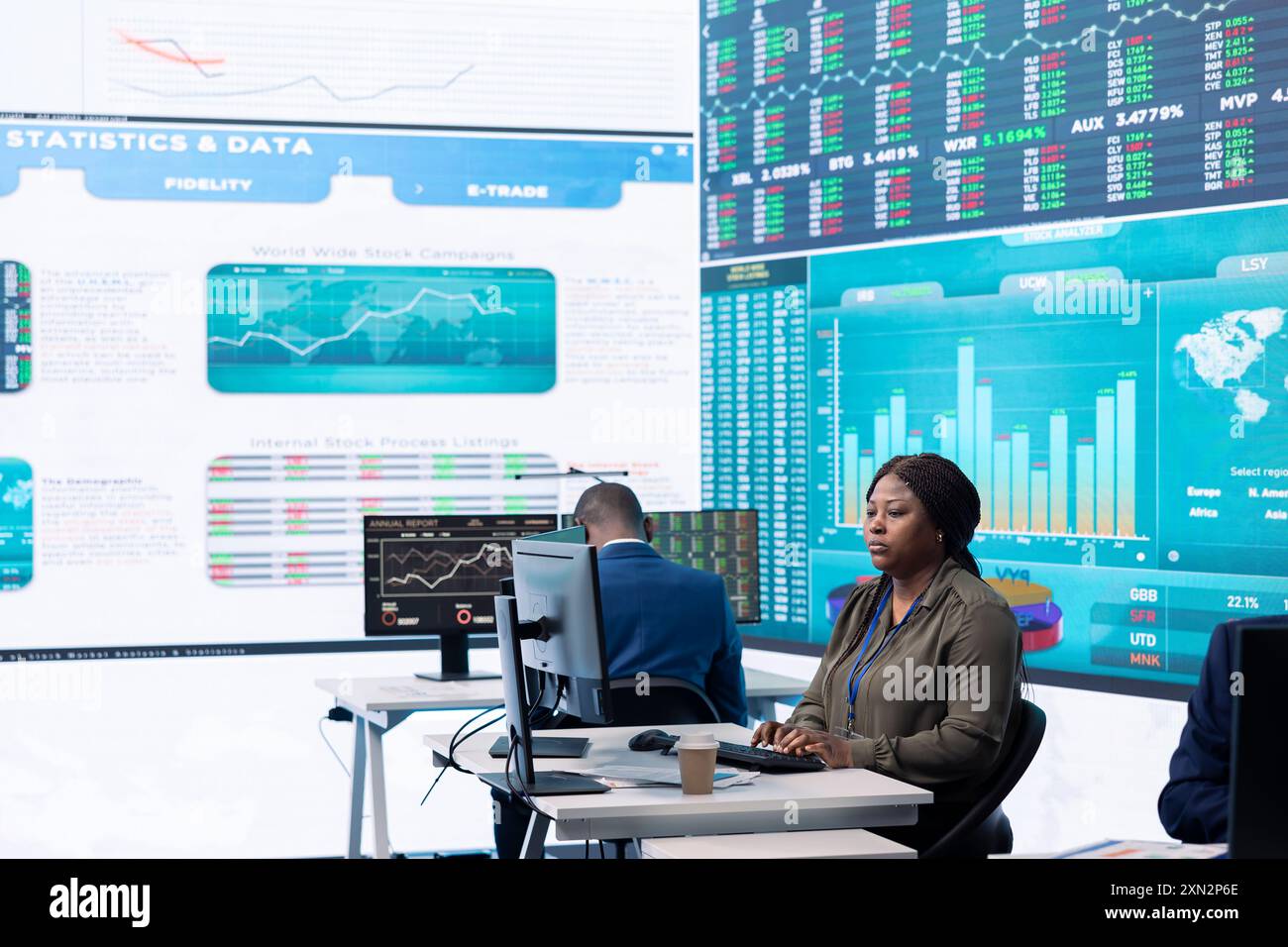 Chief executive officer reviews data shown on big display in the office ...