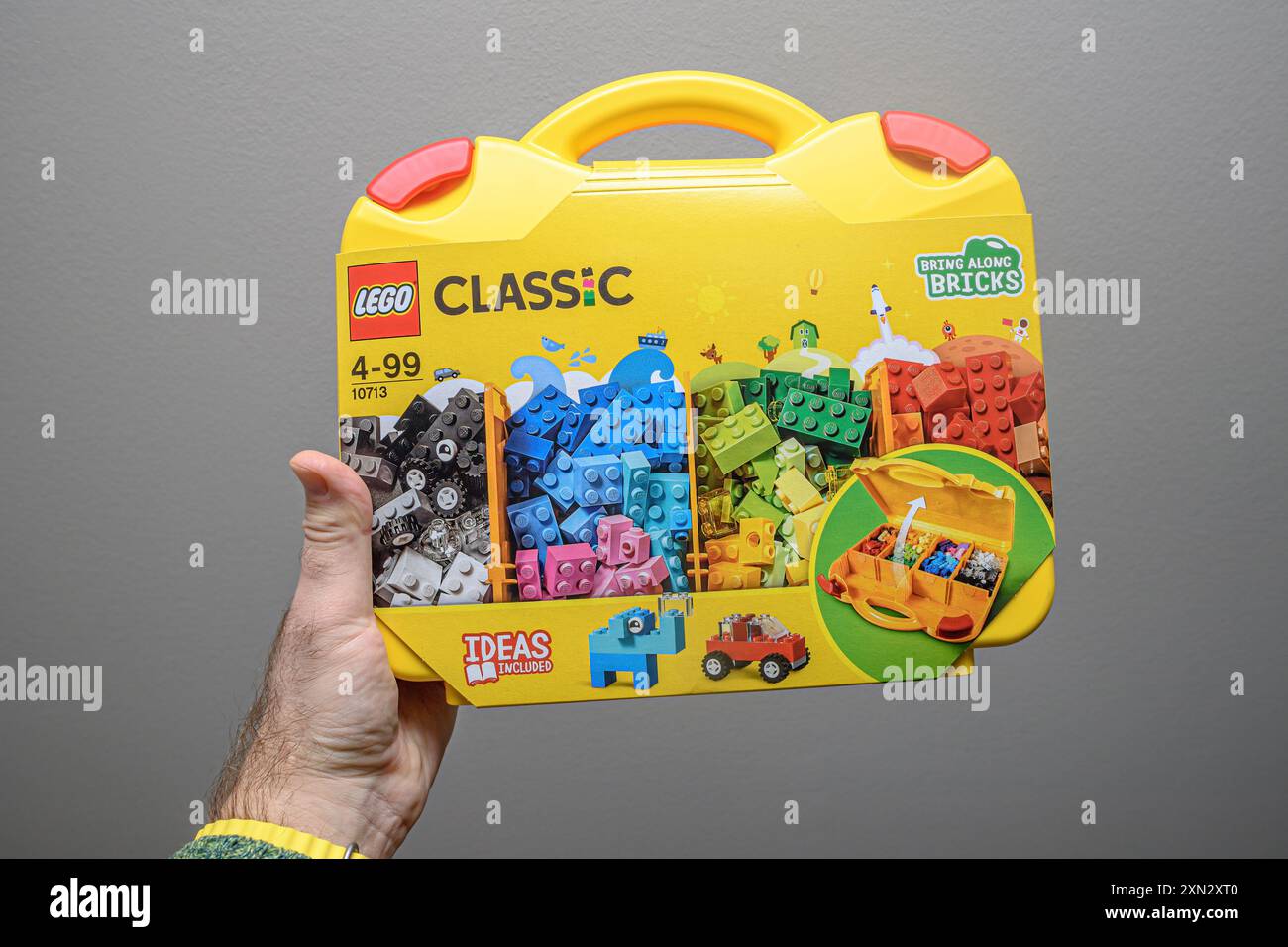 Paris, France - Mar 21, 2024: A male hand holding a LEGO Classic parts ...