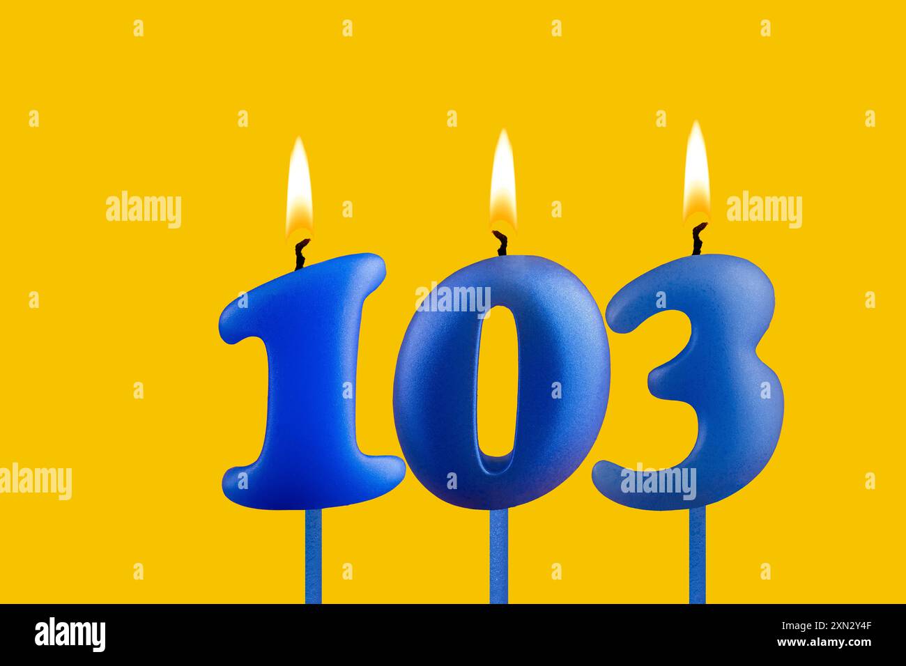 Blue birthday candle on yellow background - Number 103 Stock Photo - Alamy