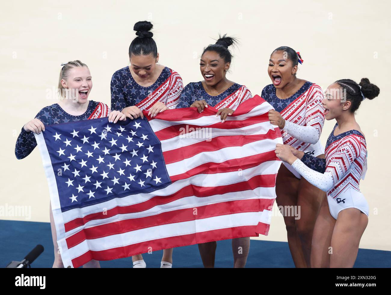 Members of the United States hold a national flag after BILES Simone's ...