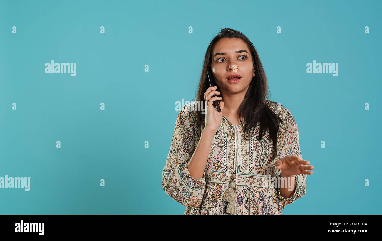 Indian woman swiping on smartphone touchscreen to answer phone call ...