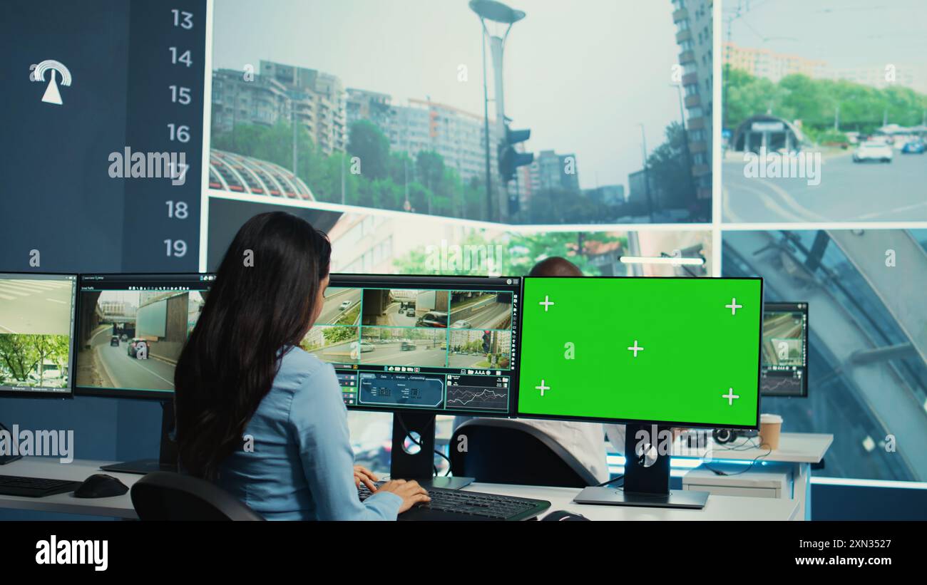 Indian woman working with surveillance footage and greenscreen on ...