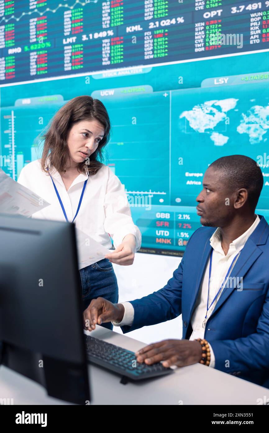 Enterprise colleagues reviewing project updates and details in ...