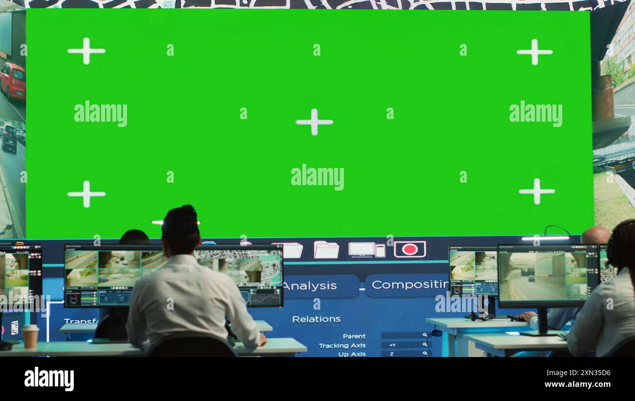 Shipping agency workers examine satellite map with huge greenscreen ...