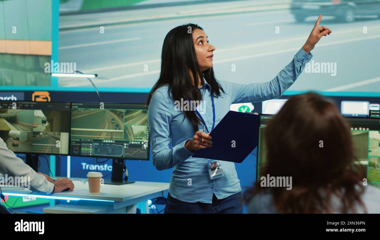 Indian supervisor assigning tasks for her operators team in observation ...