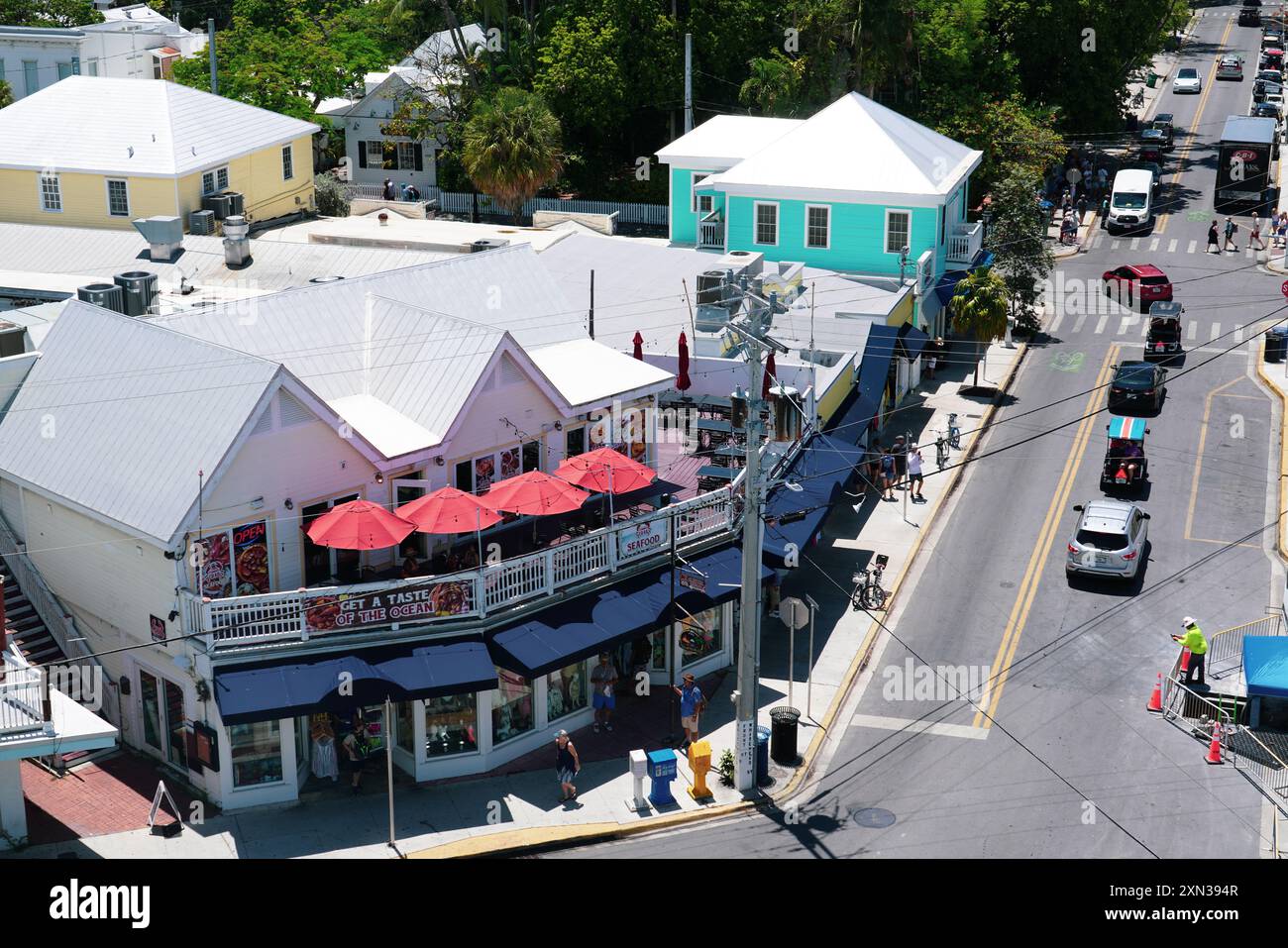A vibrant street scene in a charming coastal town featuring colorful ...