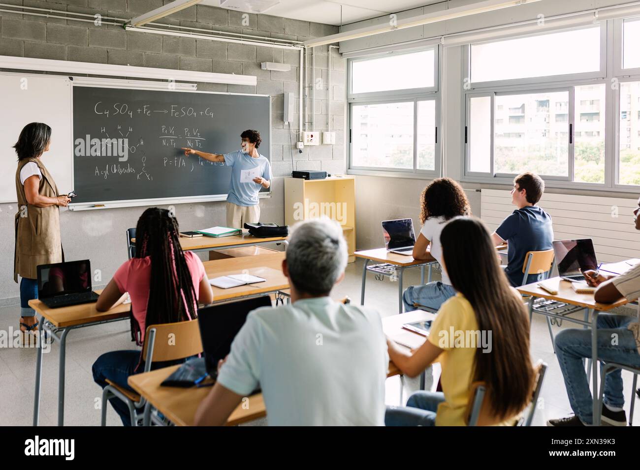 Young high school student boy giving a presentation in front of his ...