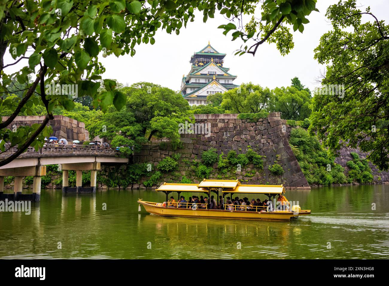 Osaka, Japan, Jun 23, 2024: Tourist ride on a yellow boat on the inner ...