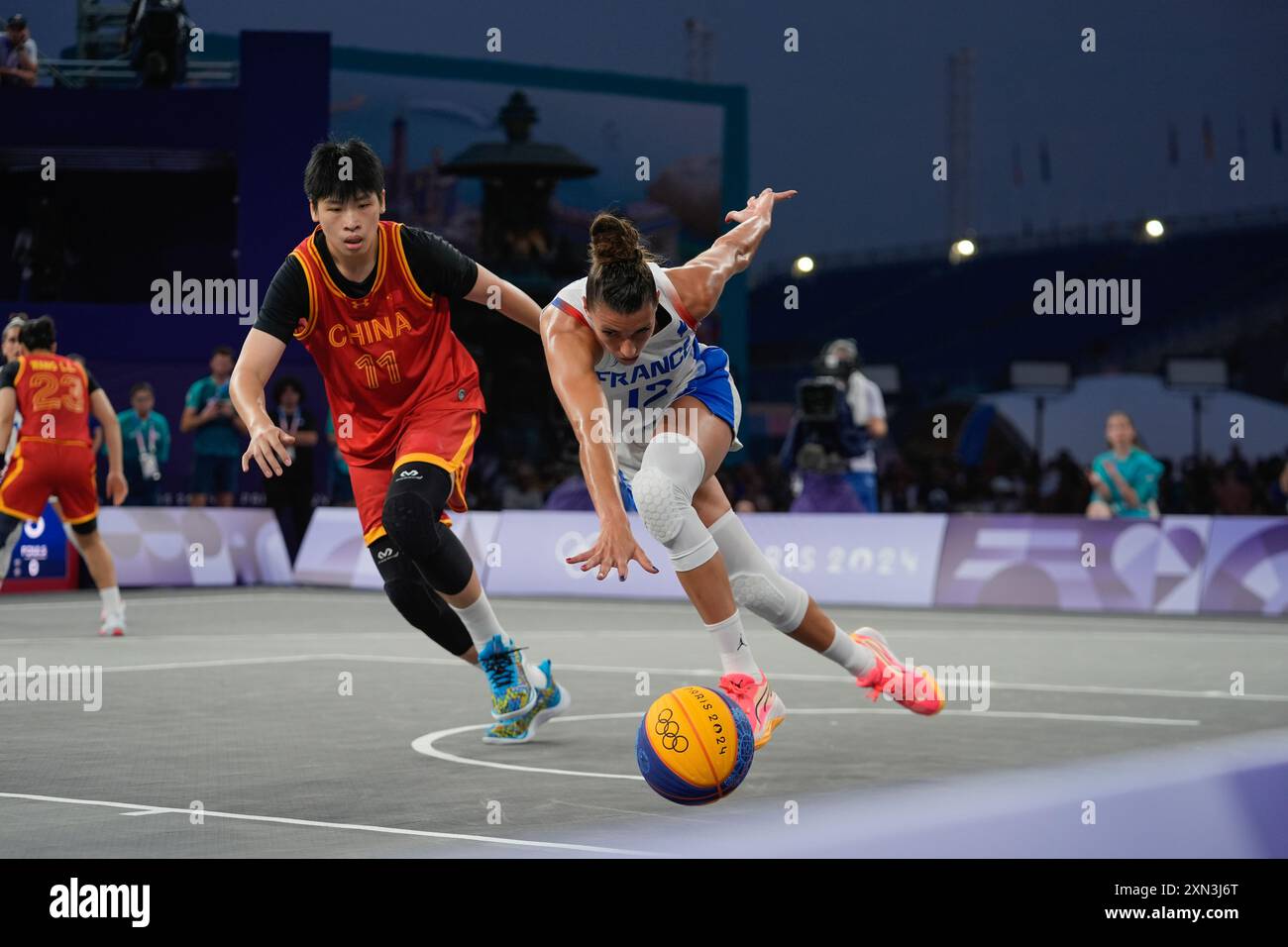 Laetitia Guapo of France, right, and Chen Mingling of China vie for a ...