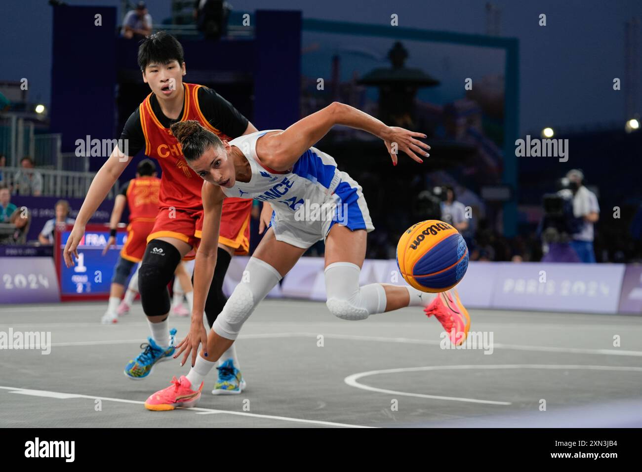 Laetitia Guapo of France, front, and Chen Mingling of China vie for a ...