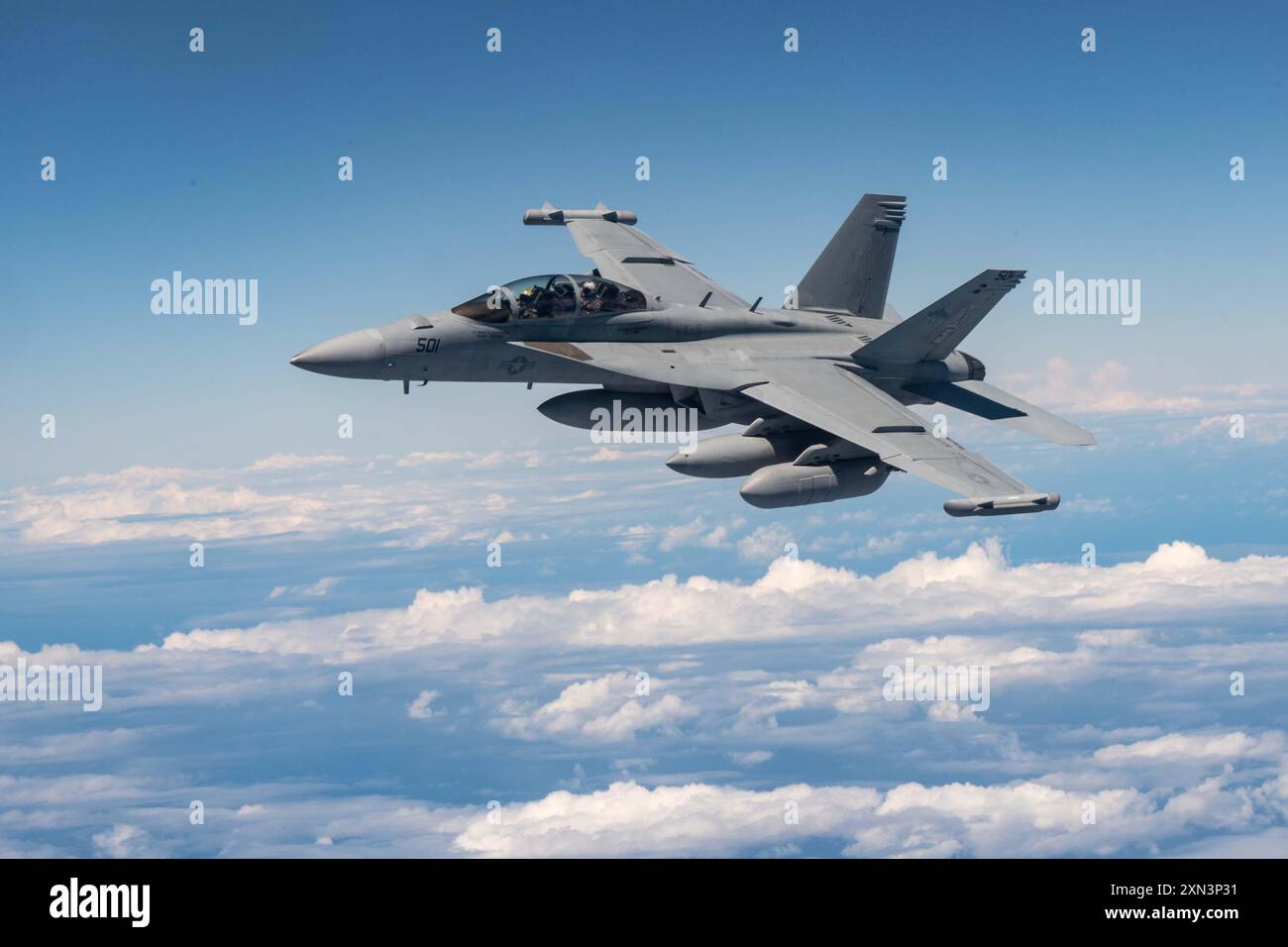 A U.S. Navy FA-18F Super Hornet departs after refueling with a U.S. Air ...