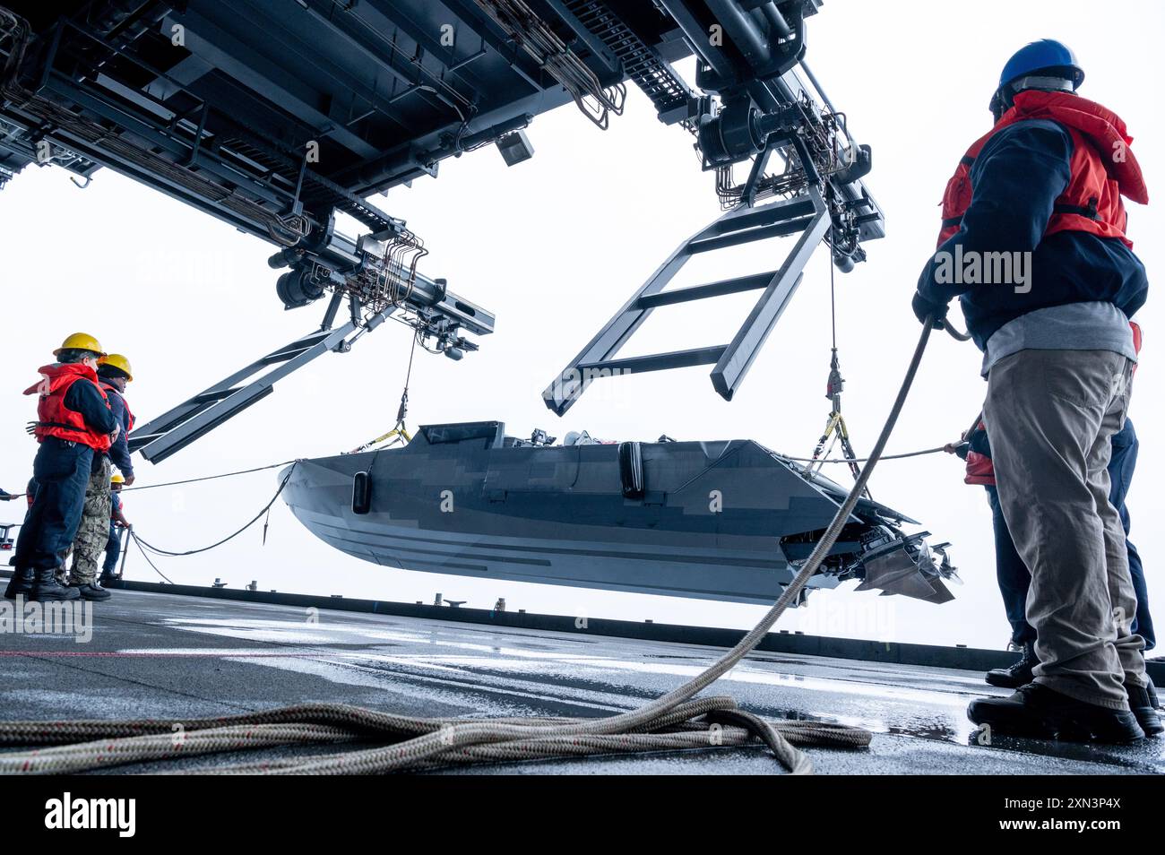 U.S. Navy sailors aboard the USS John L. Canley (ESB 6), a U.S. Navy ...