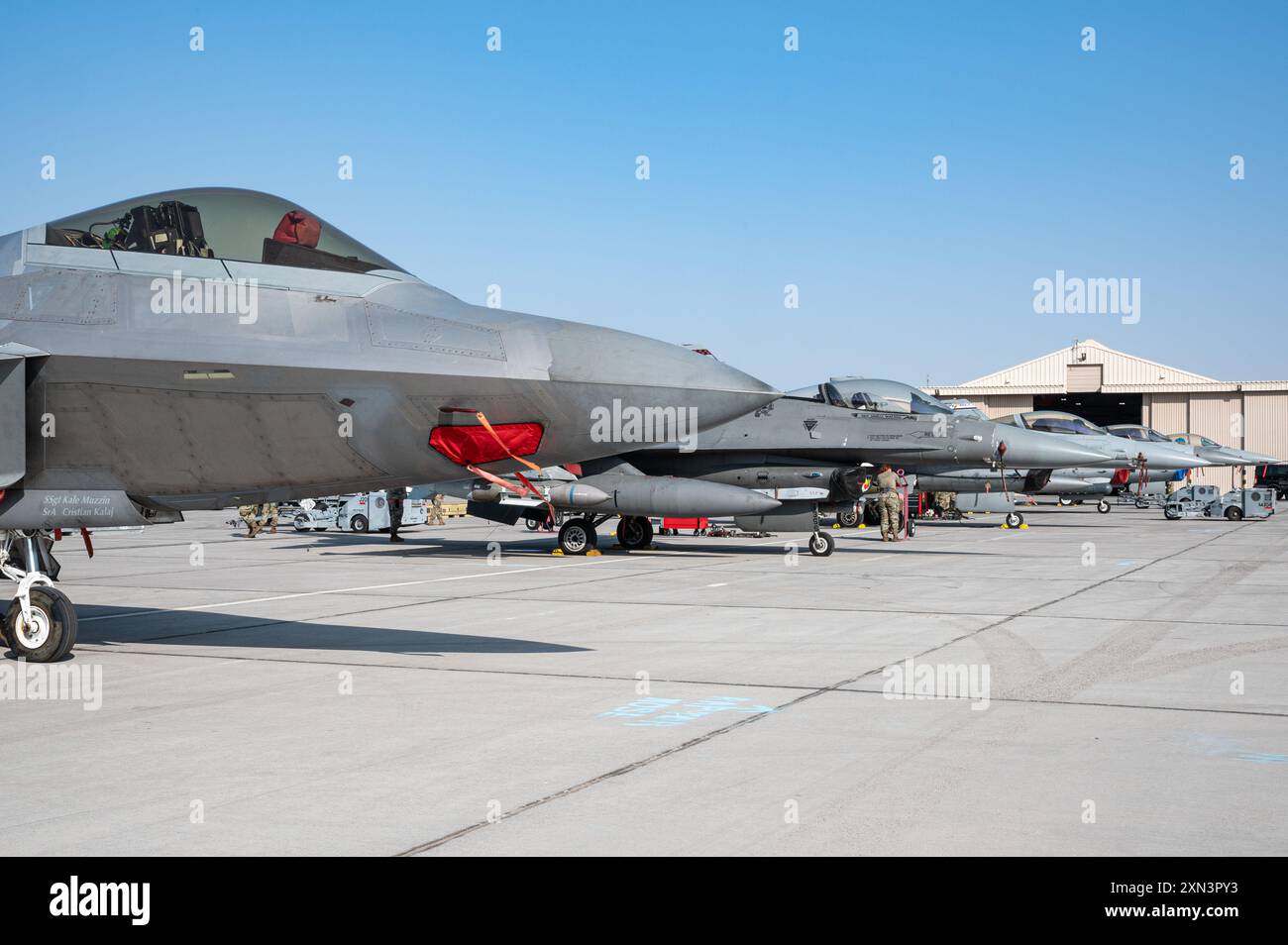 A U.S. Air Force F-22 Raptor and four F-16 Fighting Falcon assigned to ...